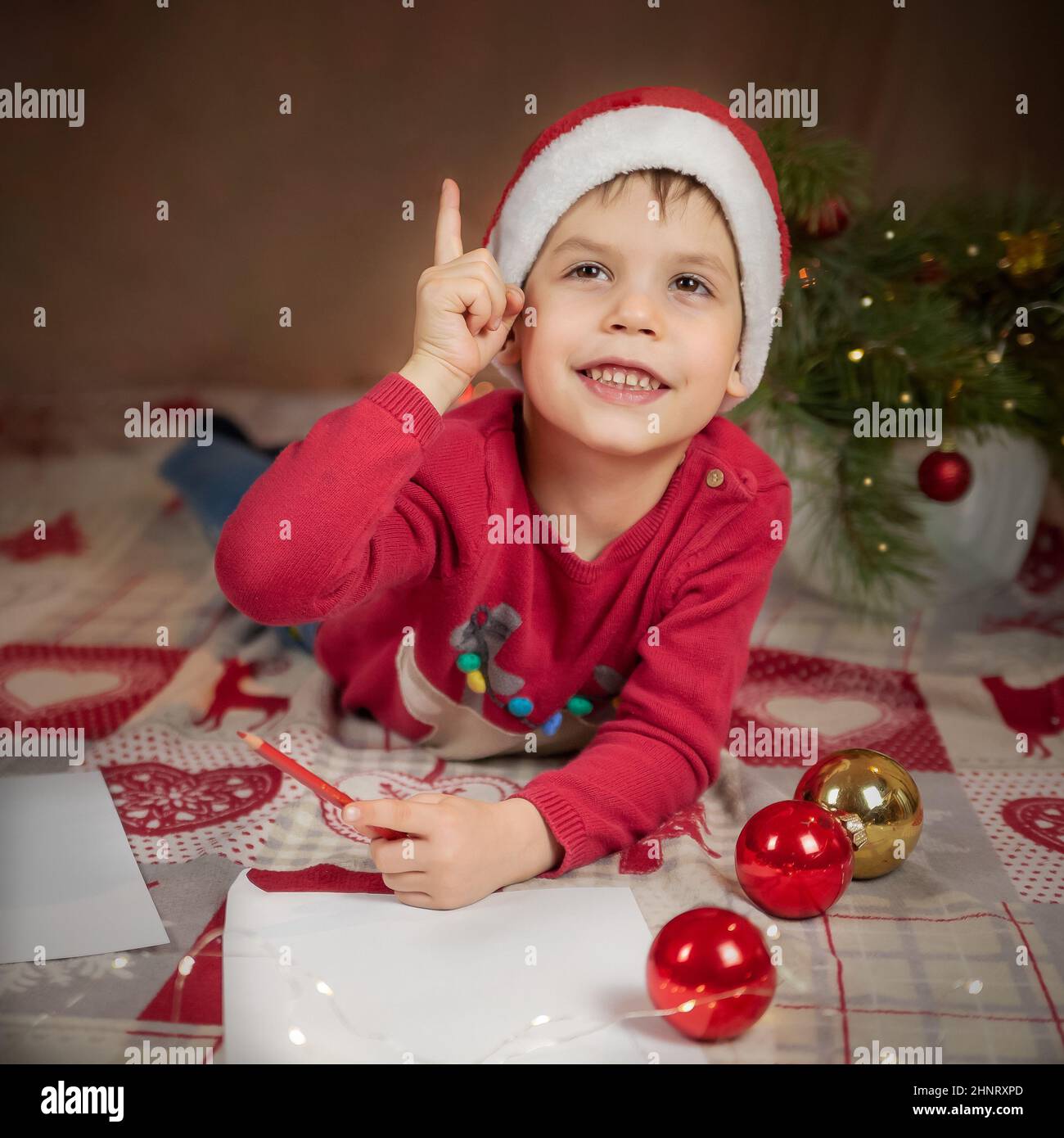 Christmas boy writing letter to Santa Claus. Christmas helper child ...