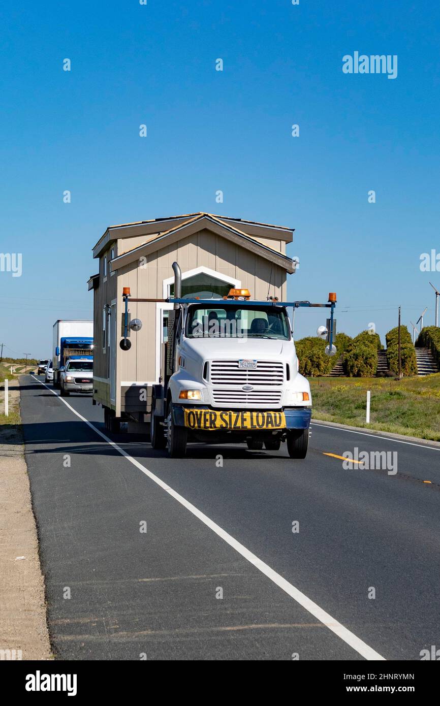 people transport their home by truck from one mobile home village to ...