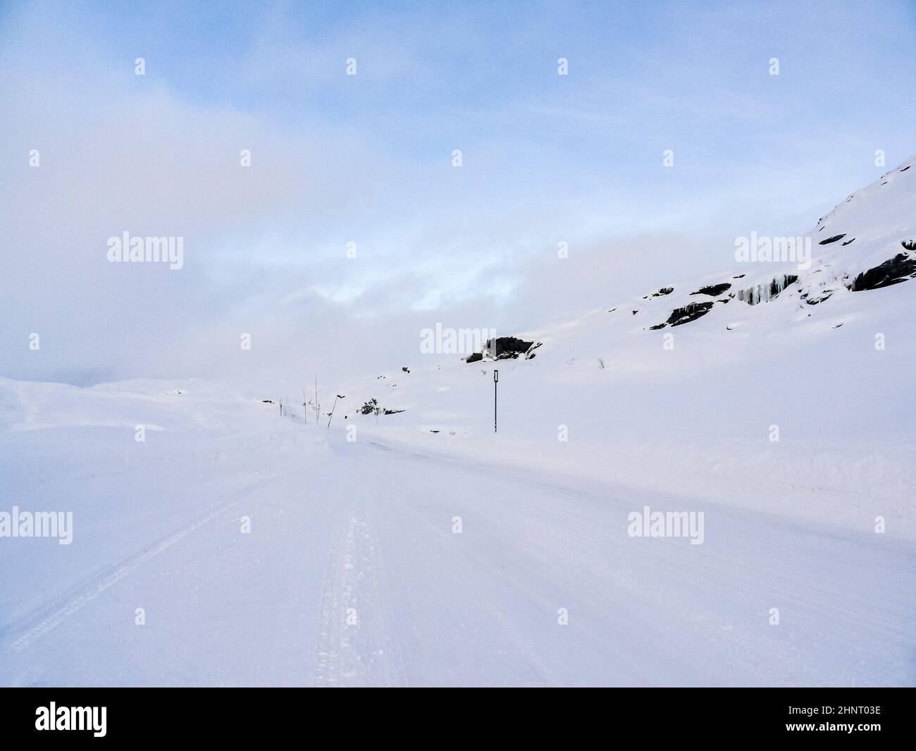 Driving through snowy white road and landscape in Norway Stock Photo ...