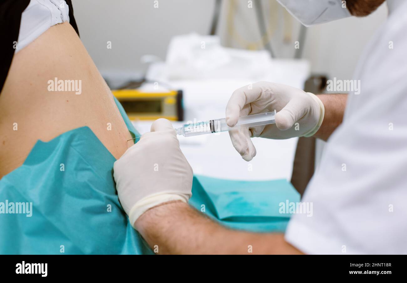 Orthopedic doctor injecting cortisone in slipped disc during ...