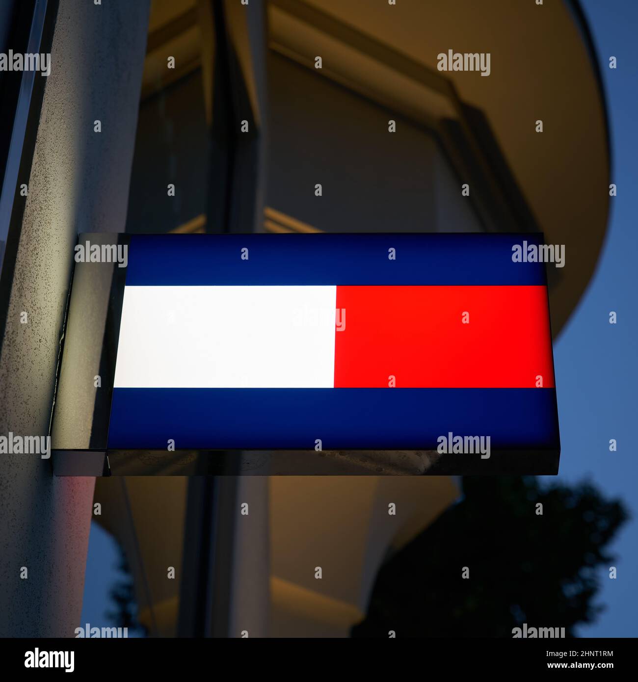 Neon light with the logo of fashion designer Tommy Hilfiger in a ...