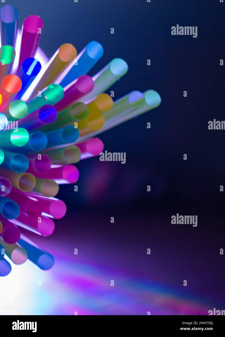 Colorful straws with party lights and blue spot light Stock Photo - Alamy