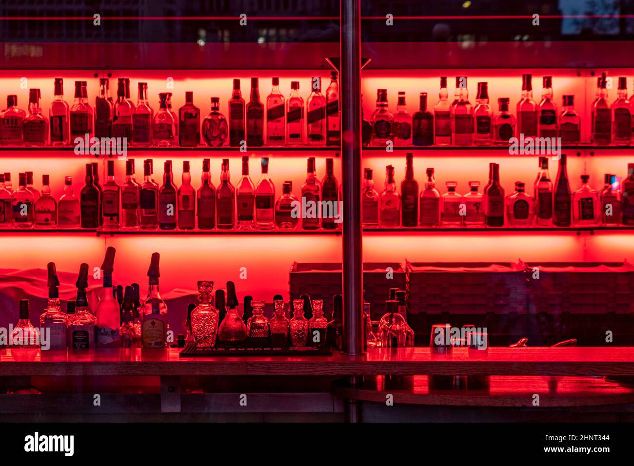 closed bar during corona shutdown with red illuminated bar with alcohol ...