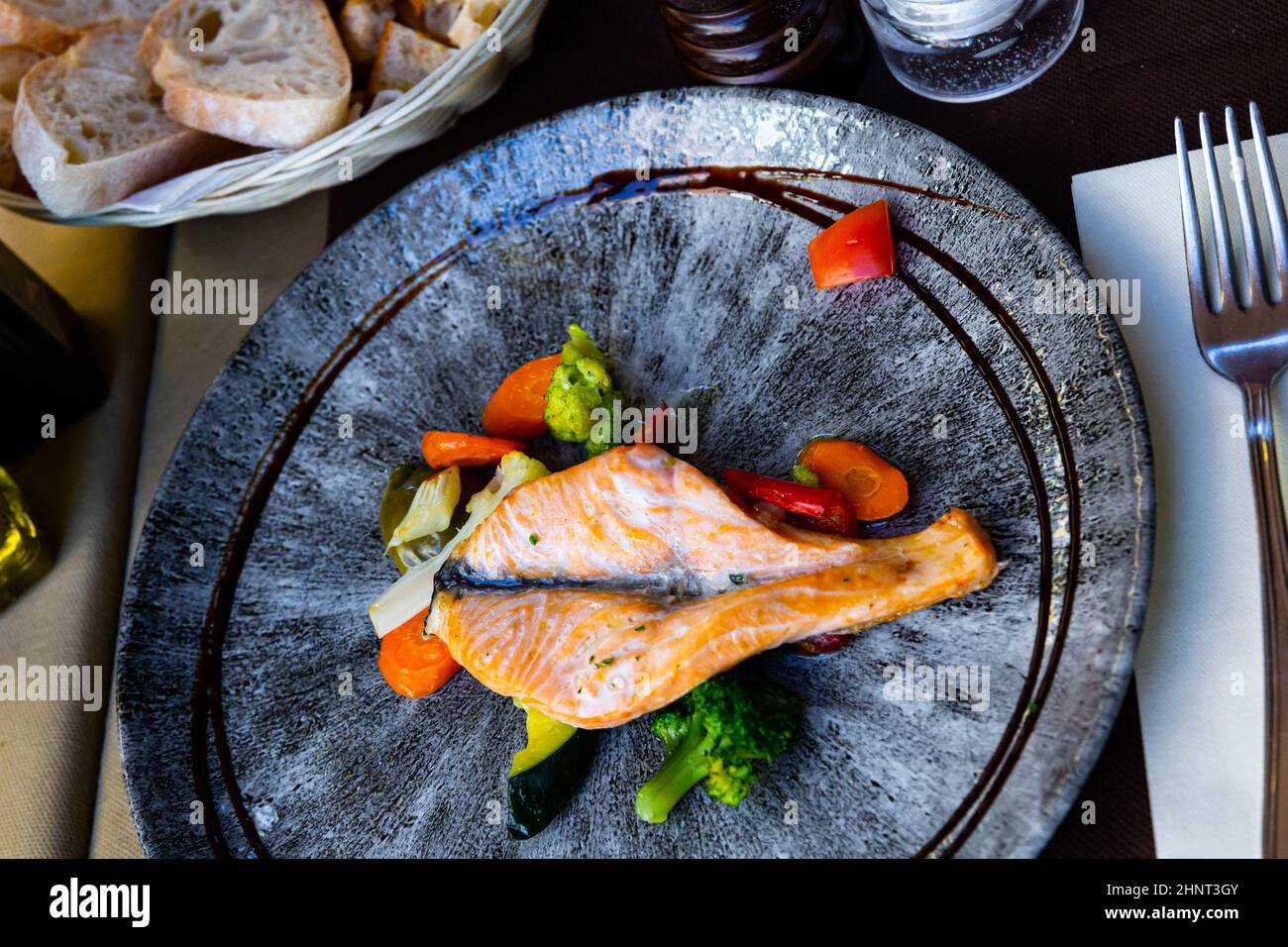 Salmon fish with vegetables served at plate with balsamic Stock Photo ...
