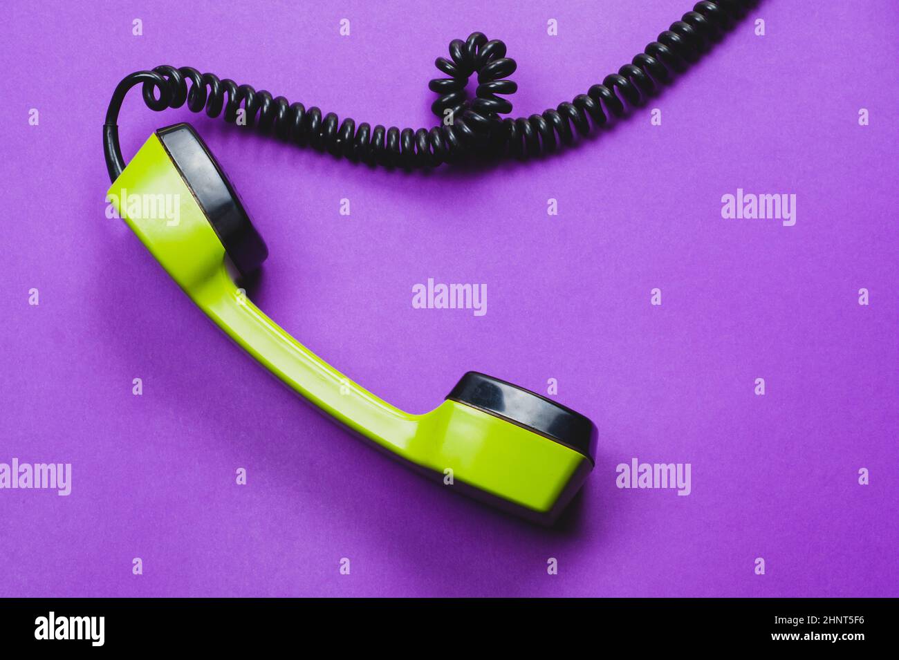 Vintage telephone handset. phone receiver isolated on purple background ...