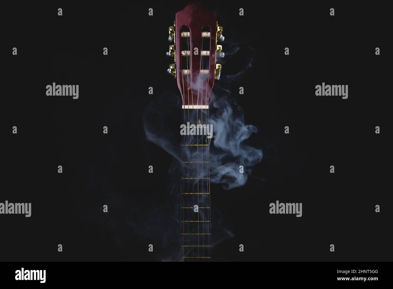 Guitar in smoke on the black background. acoustic musical instrument ...