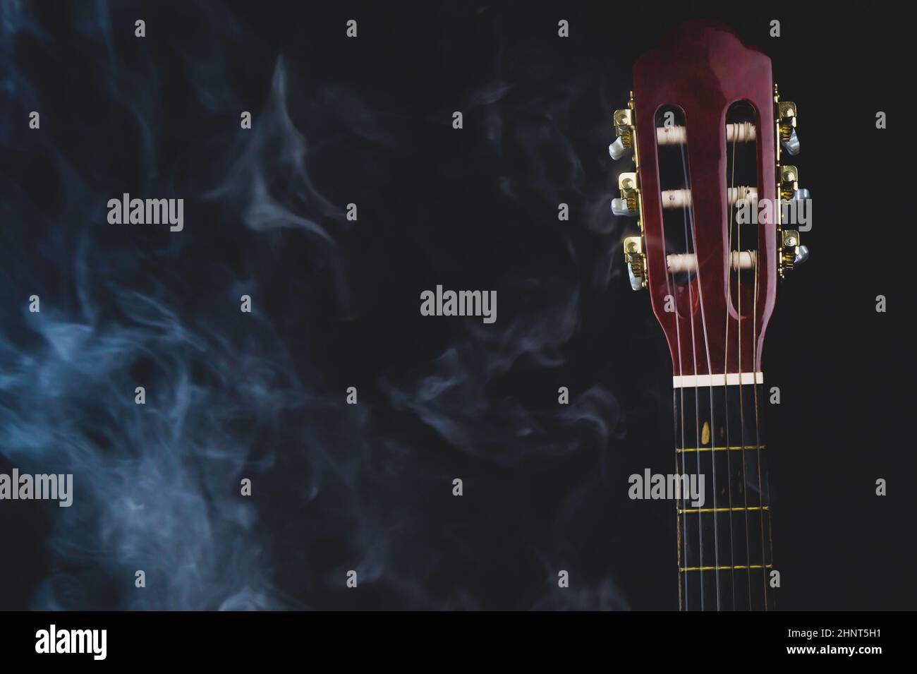 Guitar in smoke on the black background. acoustic musical instrument ...