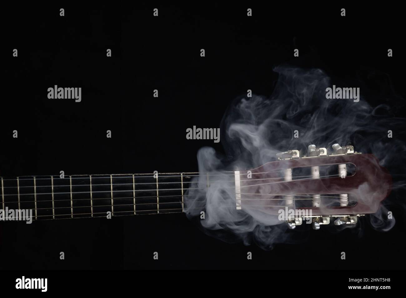Guitar in smoke on the black background. acoustic musical instrument ...