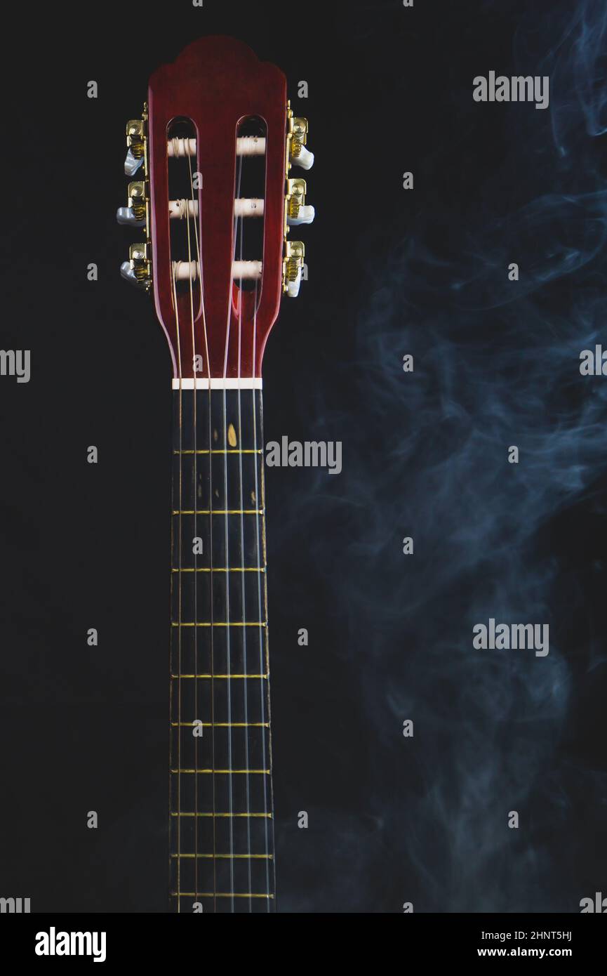 Guitar in smoke on the black background. acoustic musical instrument ...