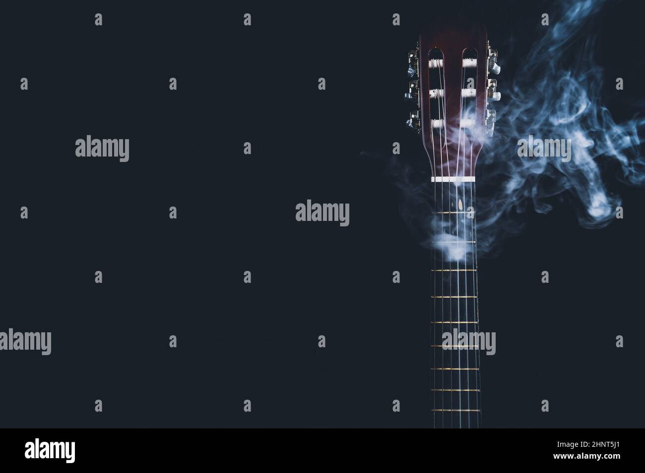 Guitar in smoke on the black background. acoustic musical instrument ...
