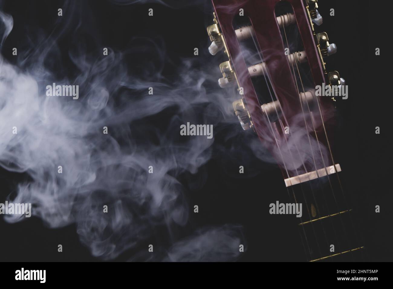 Guitar in smoke on the black background. acoustic musical instrument ...