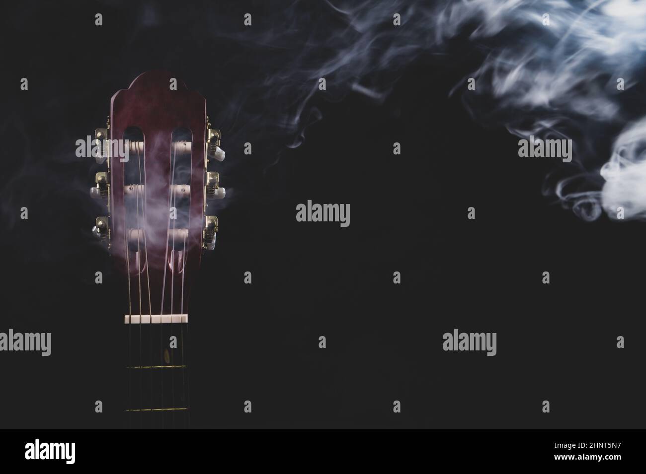 Guitar in smoke on the black background. acoustic musical instrument ...