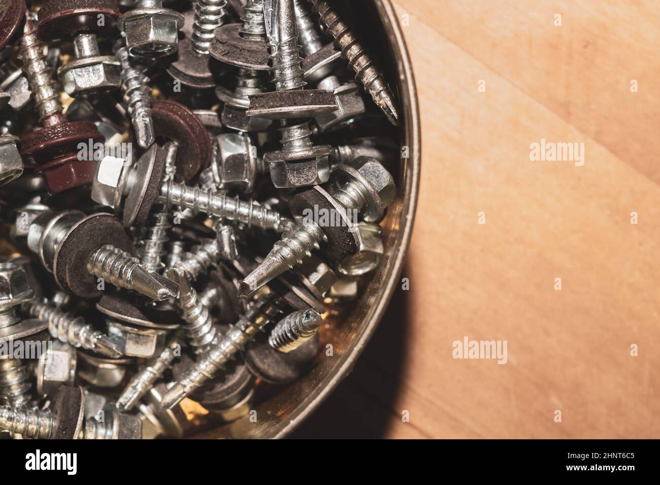 Old screws in a box. a lot of various screws. pile of fasteners in the ...