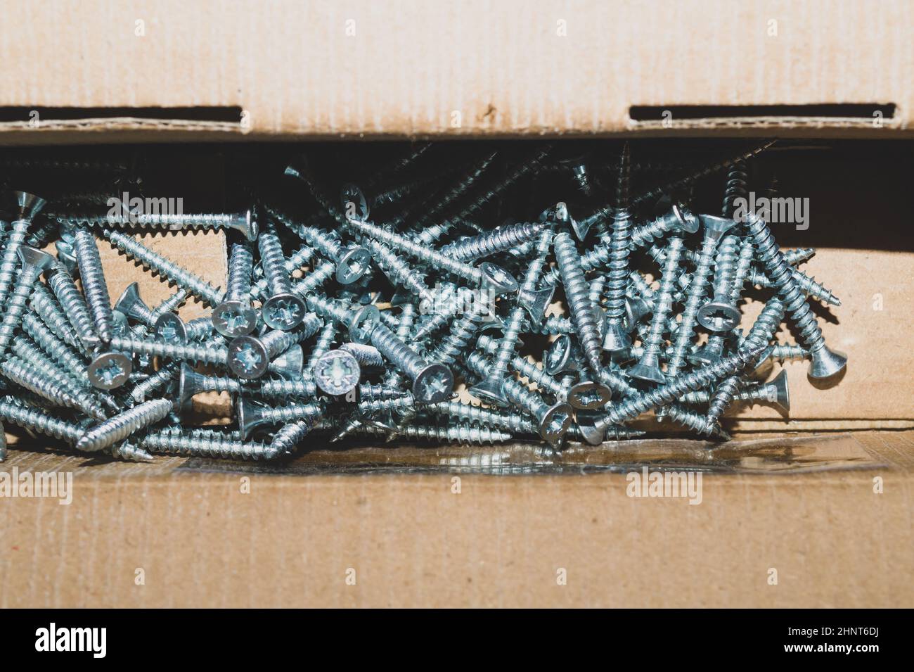 Old screws in a box. a lot of various screws. pile of fasteners in the ...