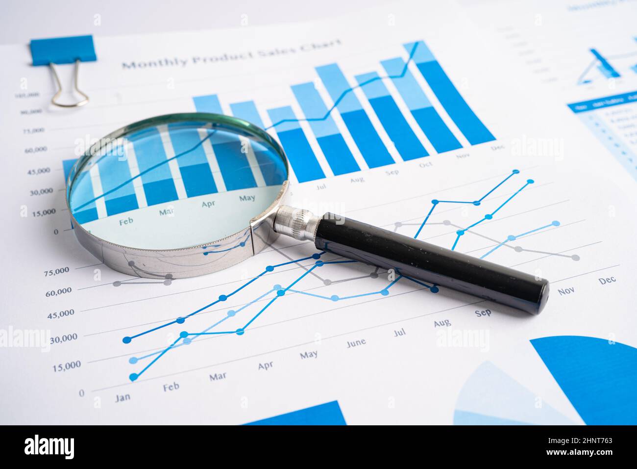 Magnifying glass on charts graphs paper. Financial development, Banking ...