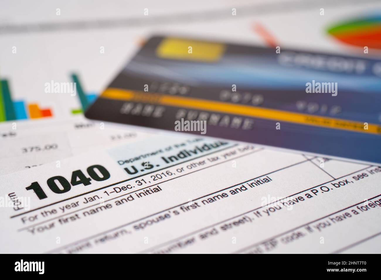 Tax Return form 1040 with credit card on graph, U.S. Individual Income ...