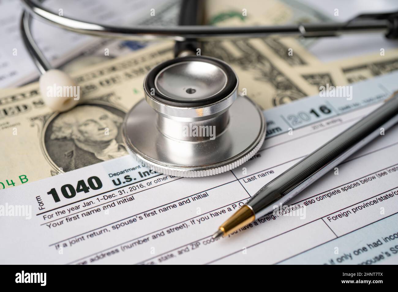 Tax Return form 1040 and dollar banknote, U.S. Individual Income Stock Photo - Alamy