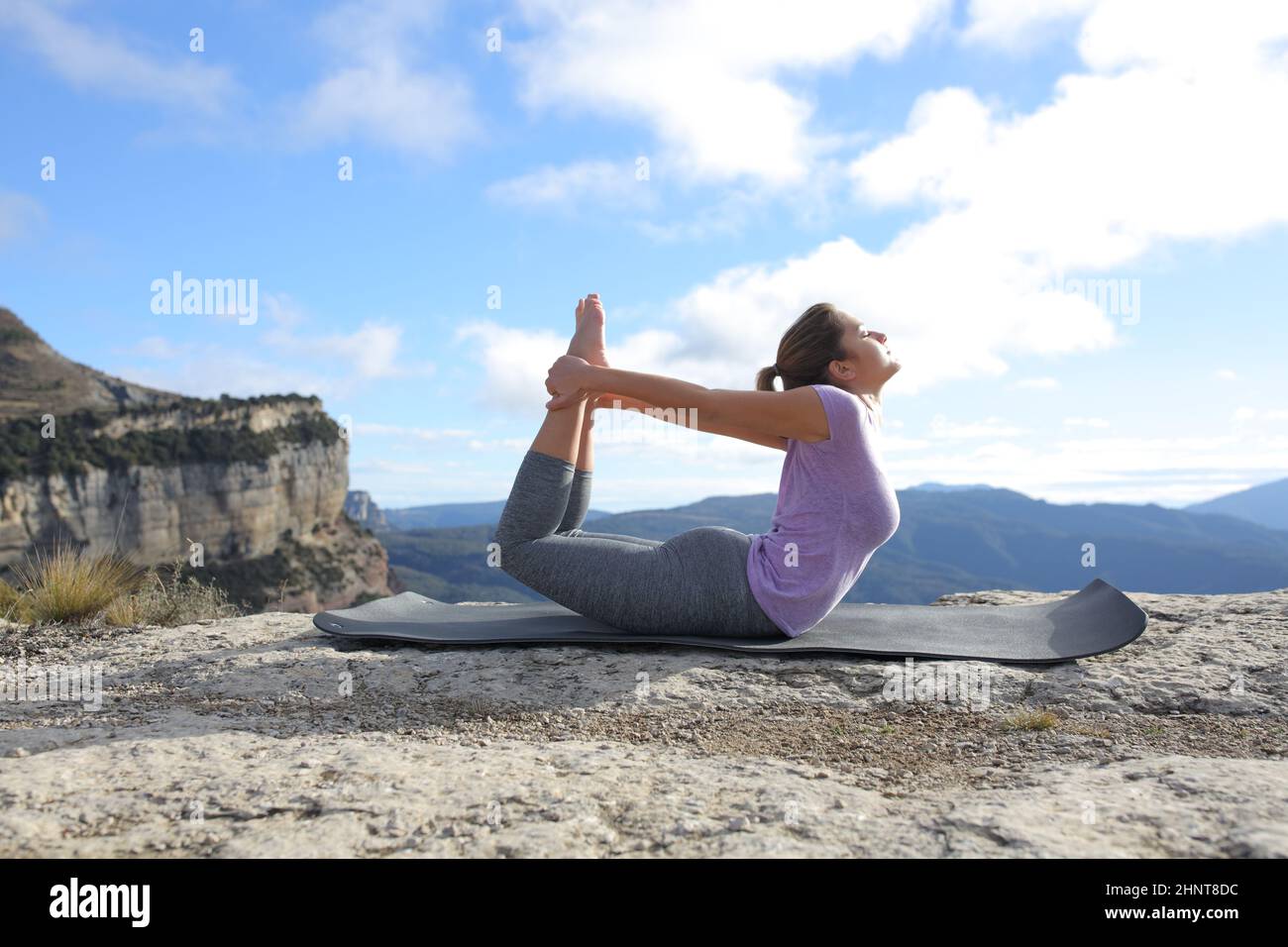 Profile of a single woman doing yoga poses in the mountain Stock Photo ...