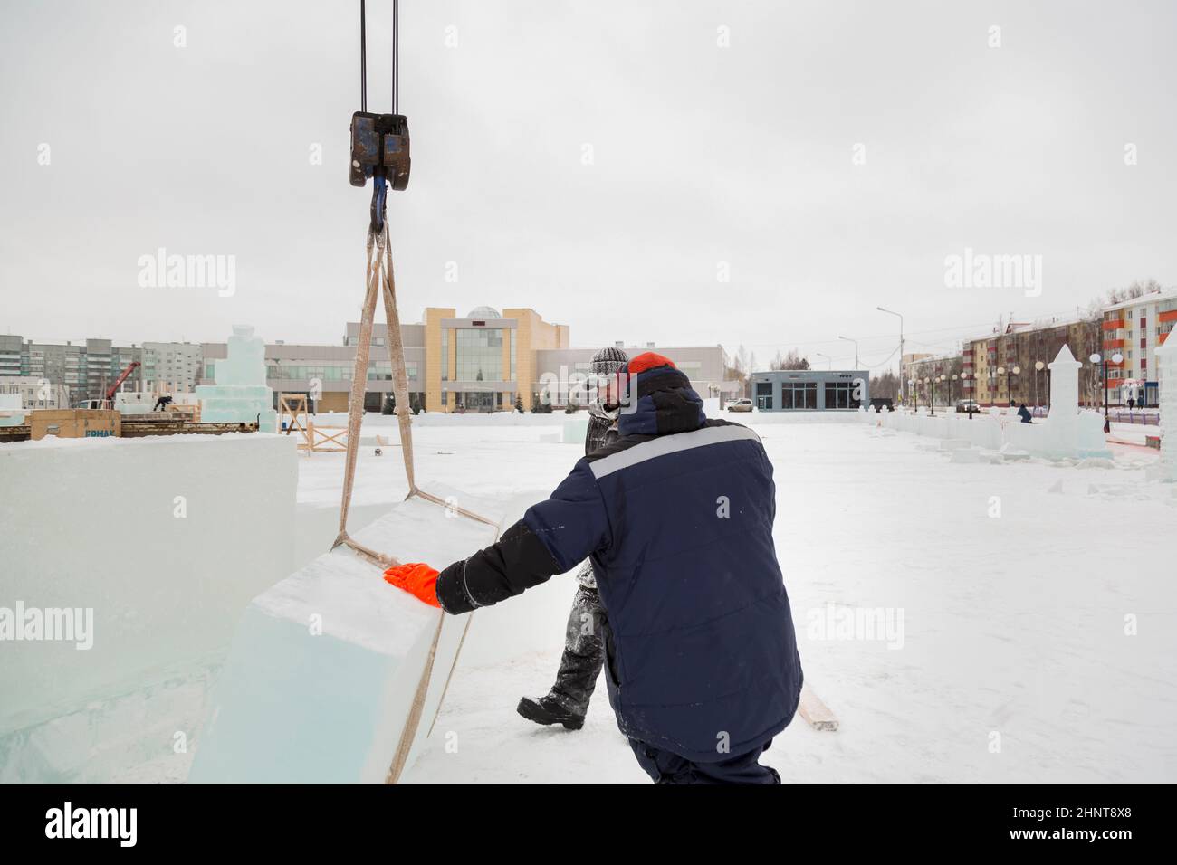 Two assembler workers store ice slabs at the construction site of the ...