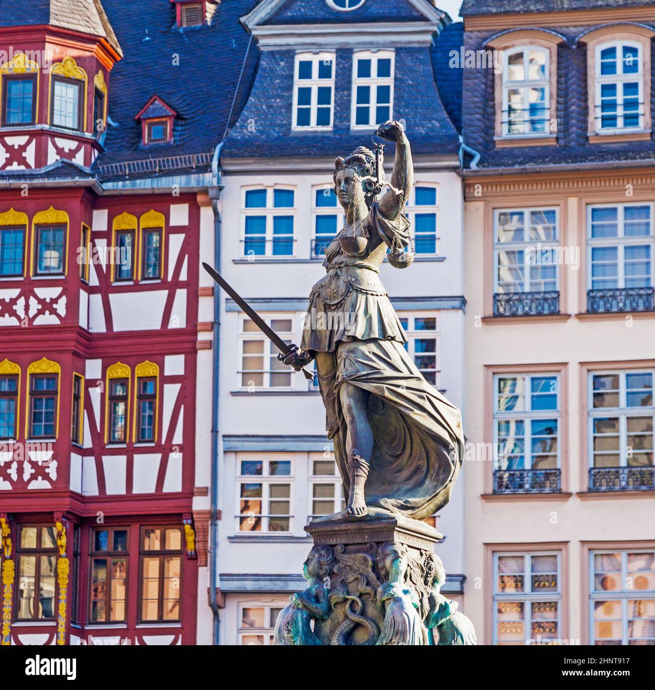 Lady Justice standing at the fountain under blue sky in Frankfurt as a ...
