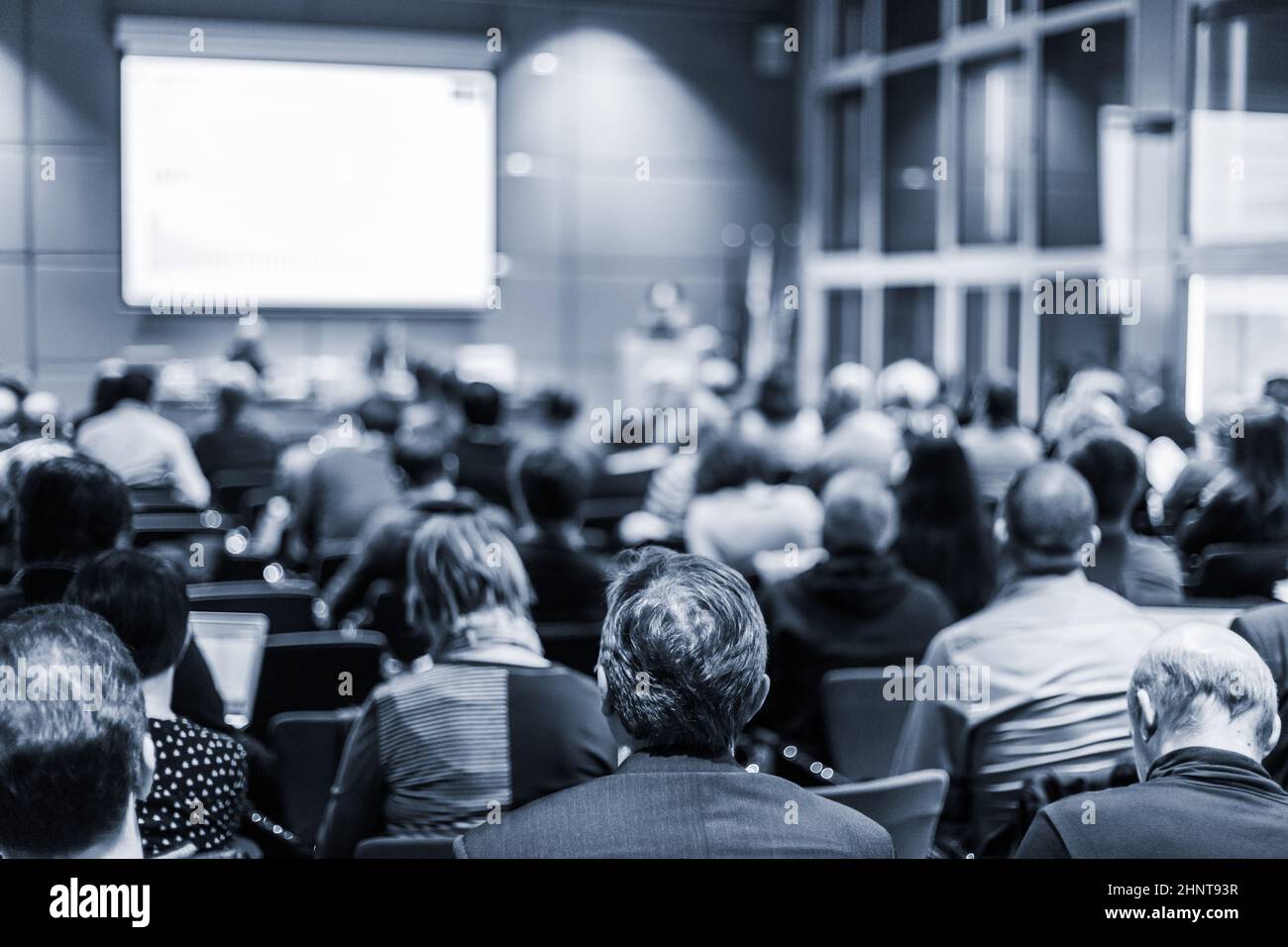 Audience in lecture hall participating at business event Stock Photo ...