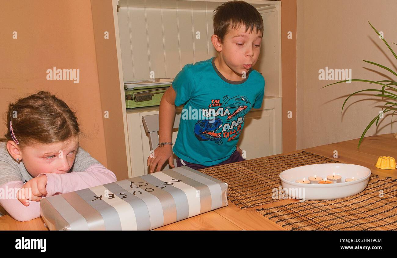 Boy celebrating the ninth birthday. Brother and his disappointed sister ...