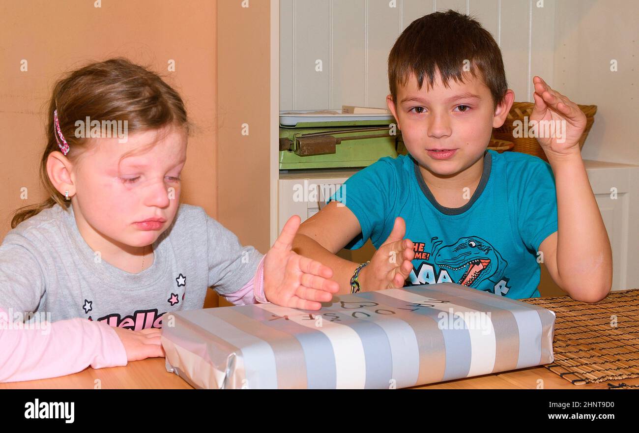 Boy celebrating the ninth birthday. Brother and his disappointed sister ...