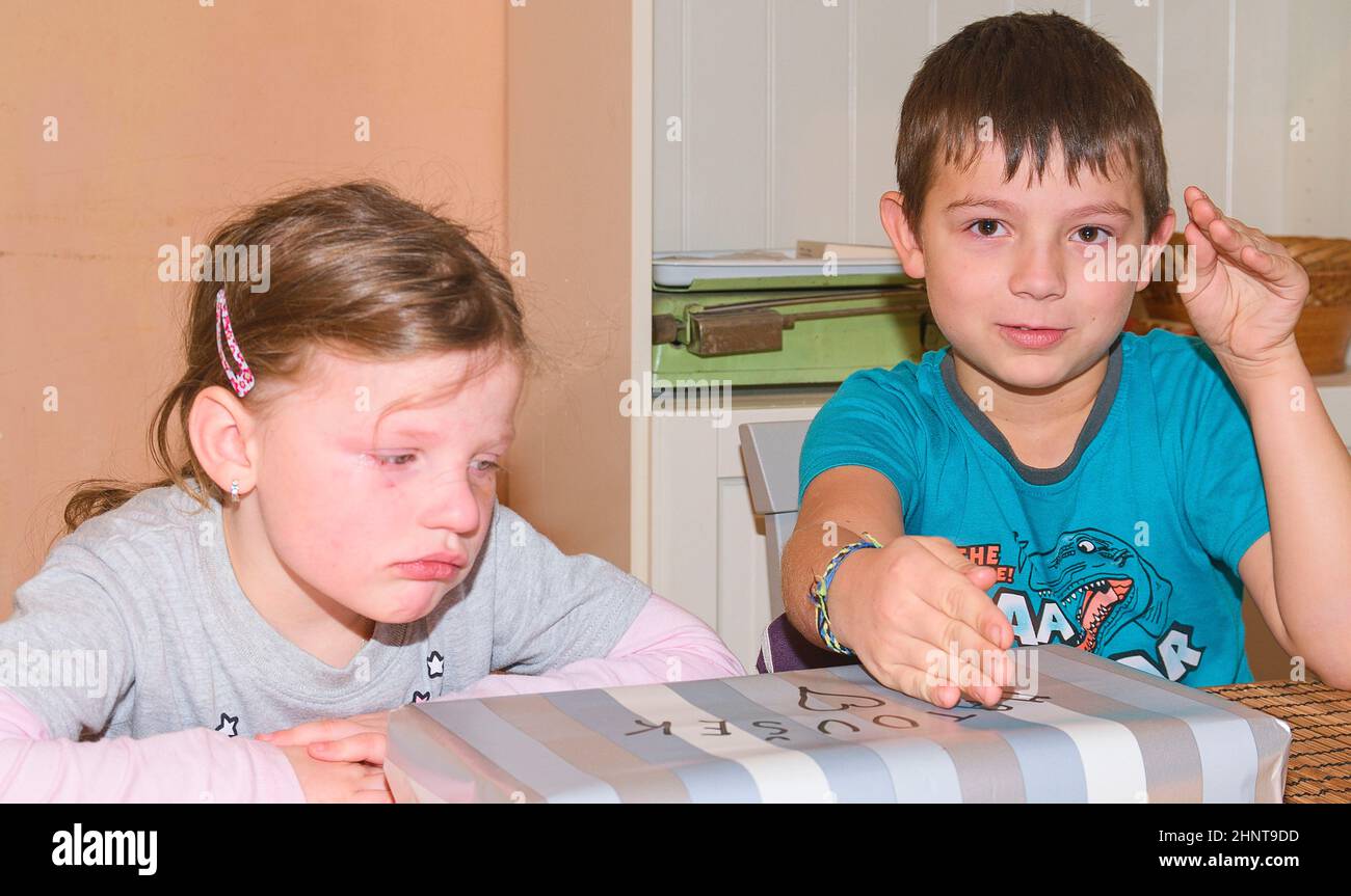 Boy celebrating the ninth birthday. Brother and his disappointed sister ...