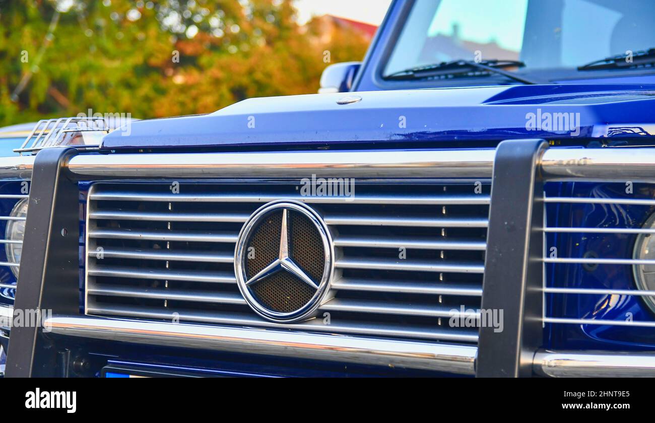 Mercedes Benz logo on blue car SUV . Mercedes-Benz is a German ...
