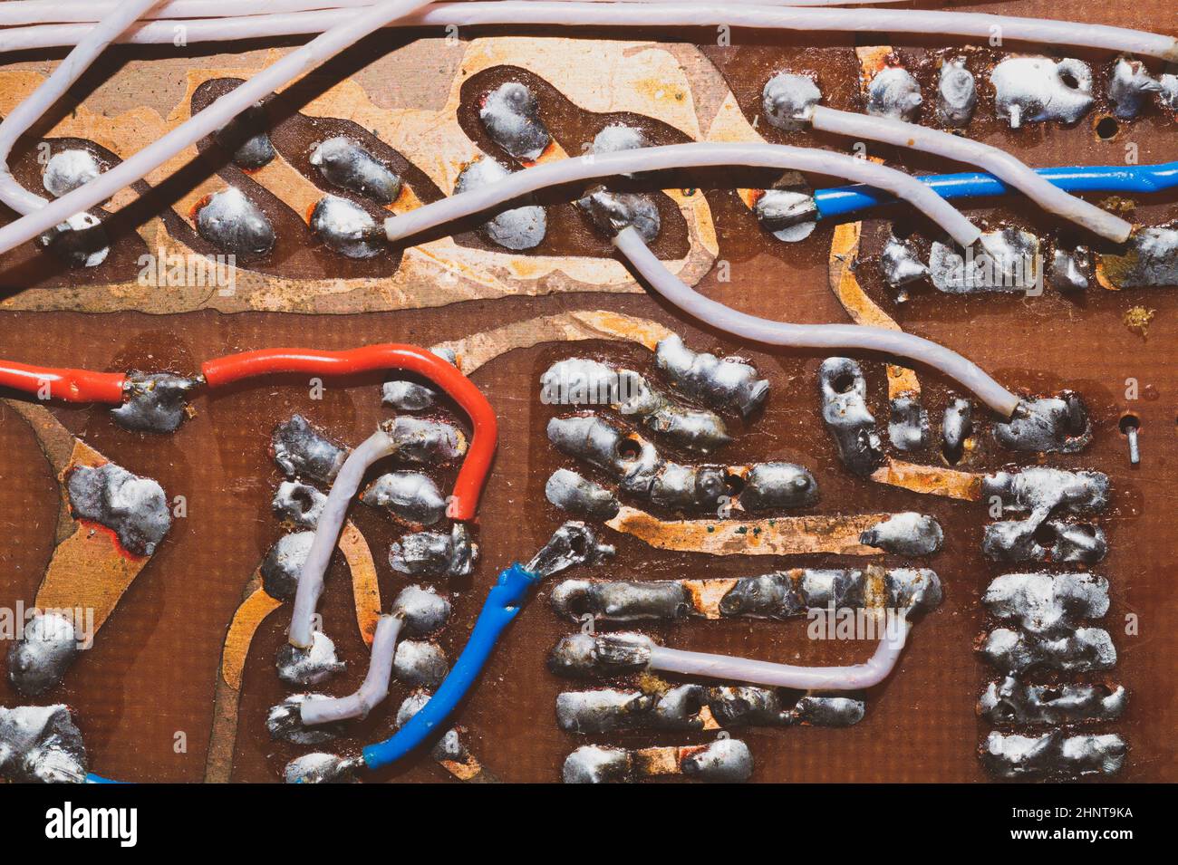 Handmade circuit board with connections and traces. colorful wires ...