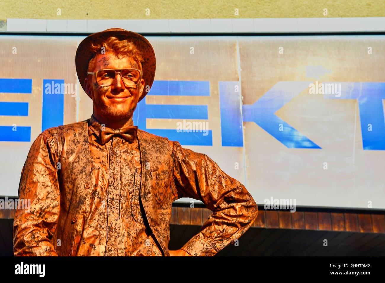 Cupreous painted artist like living statue dressed like gentleman ...