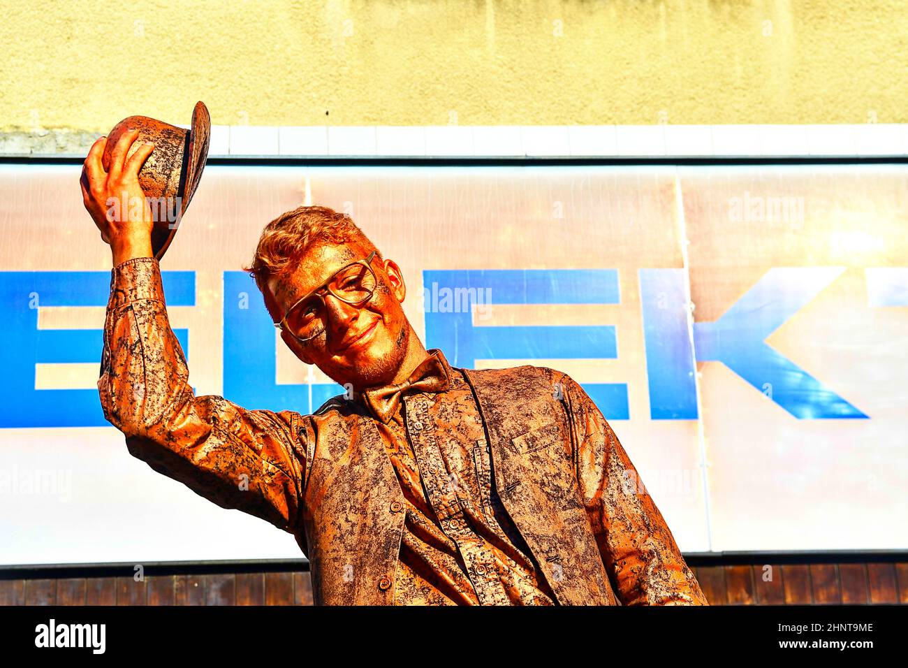 Cupreous painted artist like living statue dressed like gentleman ...