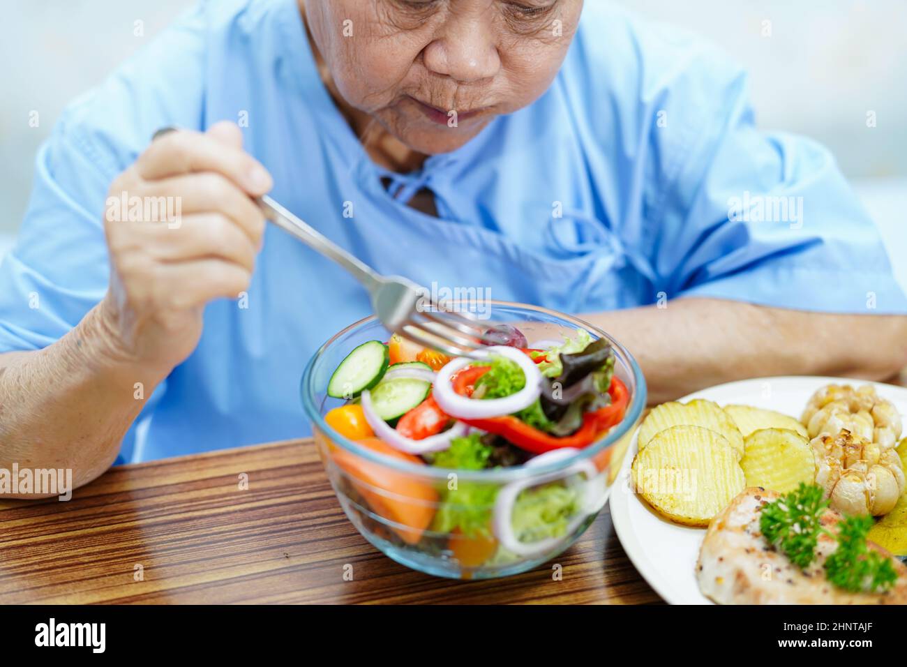 Asian senior or elderly old lady woman patient eating breakfast ...
