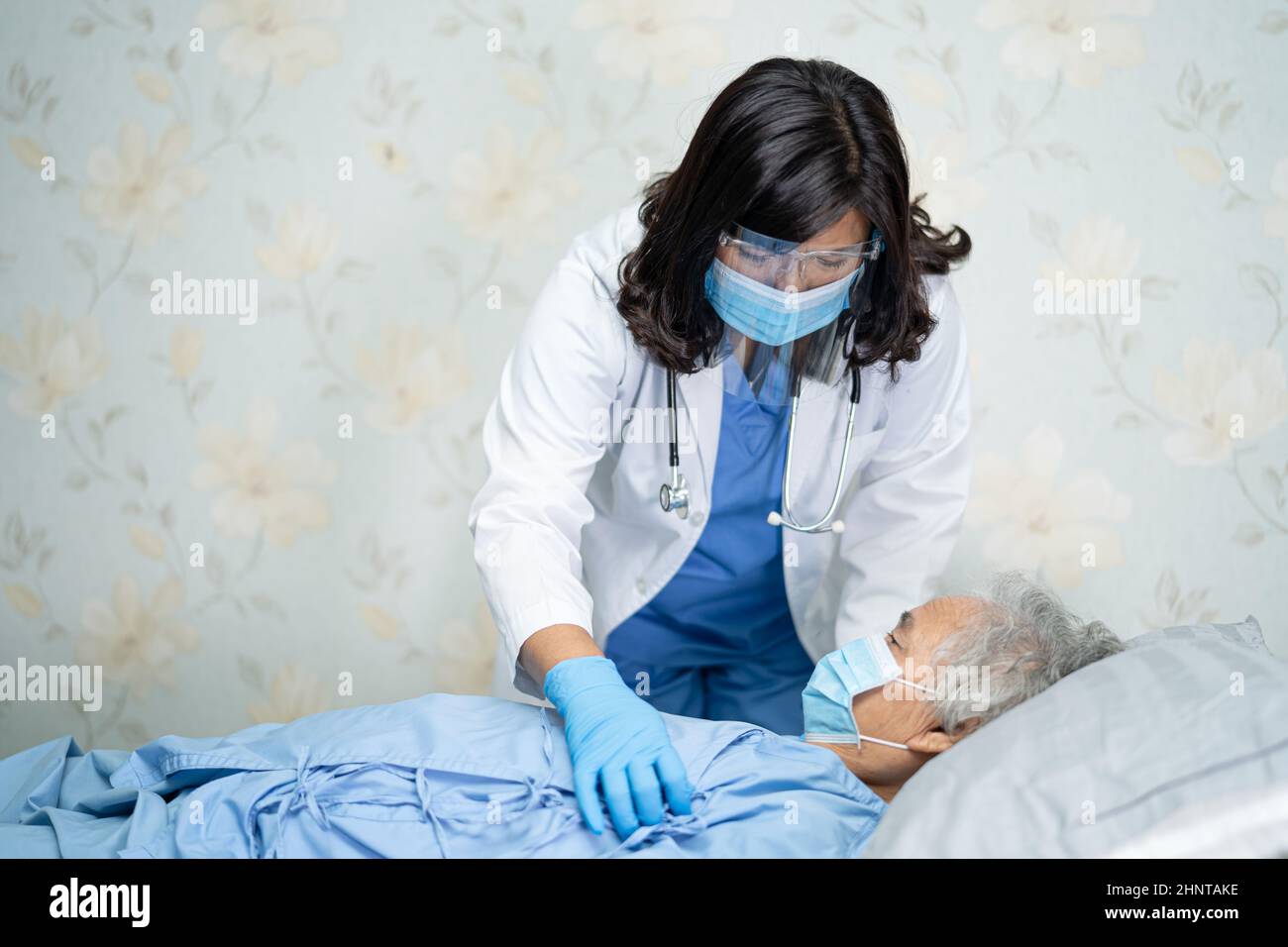 Doctor using stethoscope to checking Asian senior or elderly old lady ...