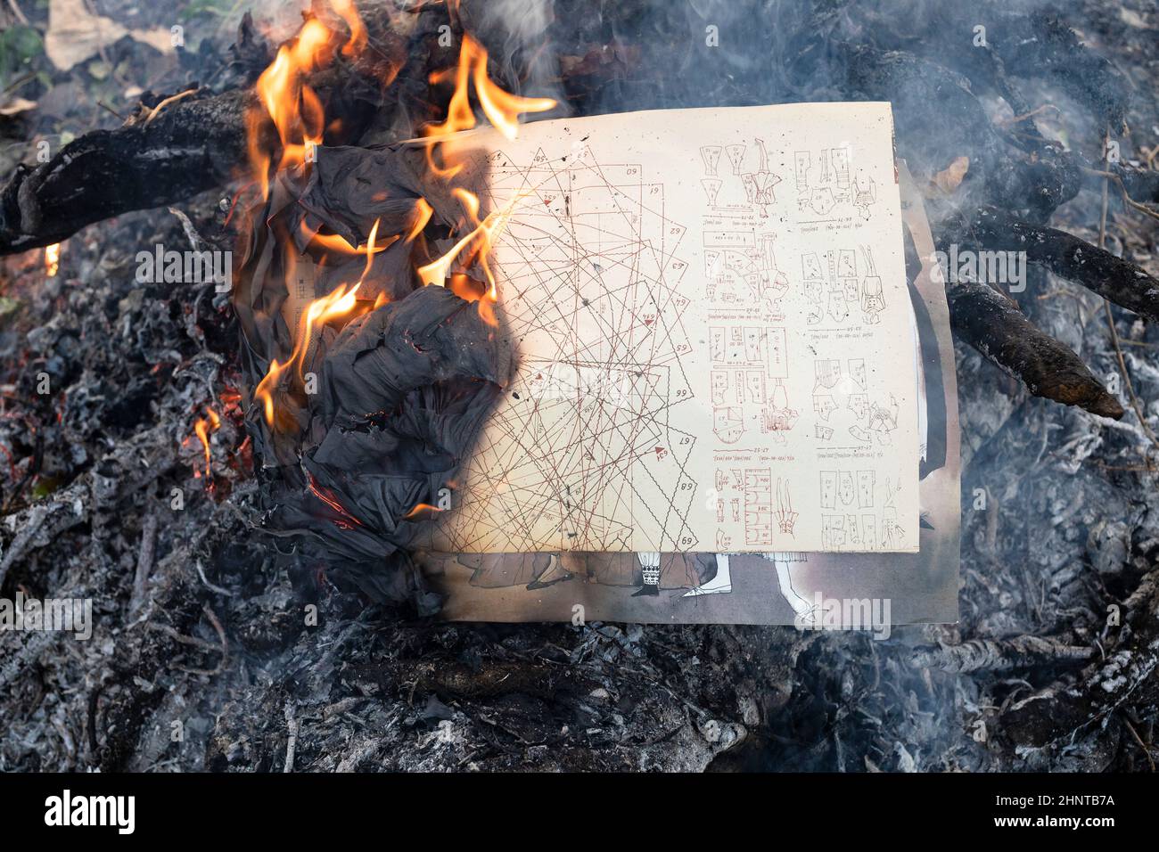 vintage cutting patterns buring in old bonfire Stock Photo - Alamy
