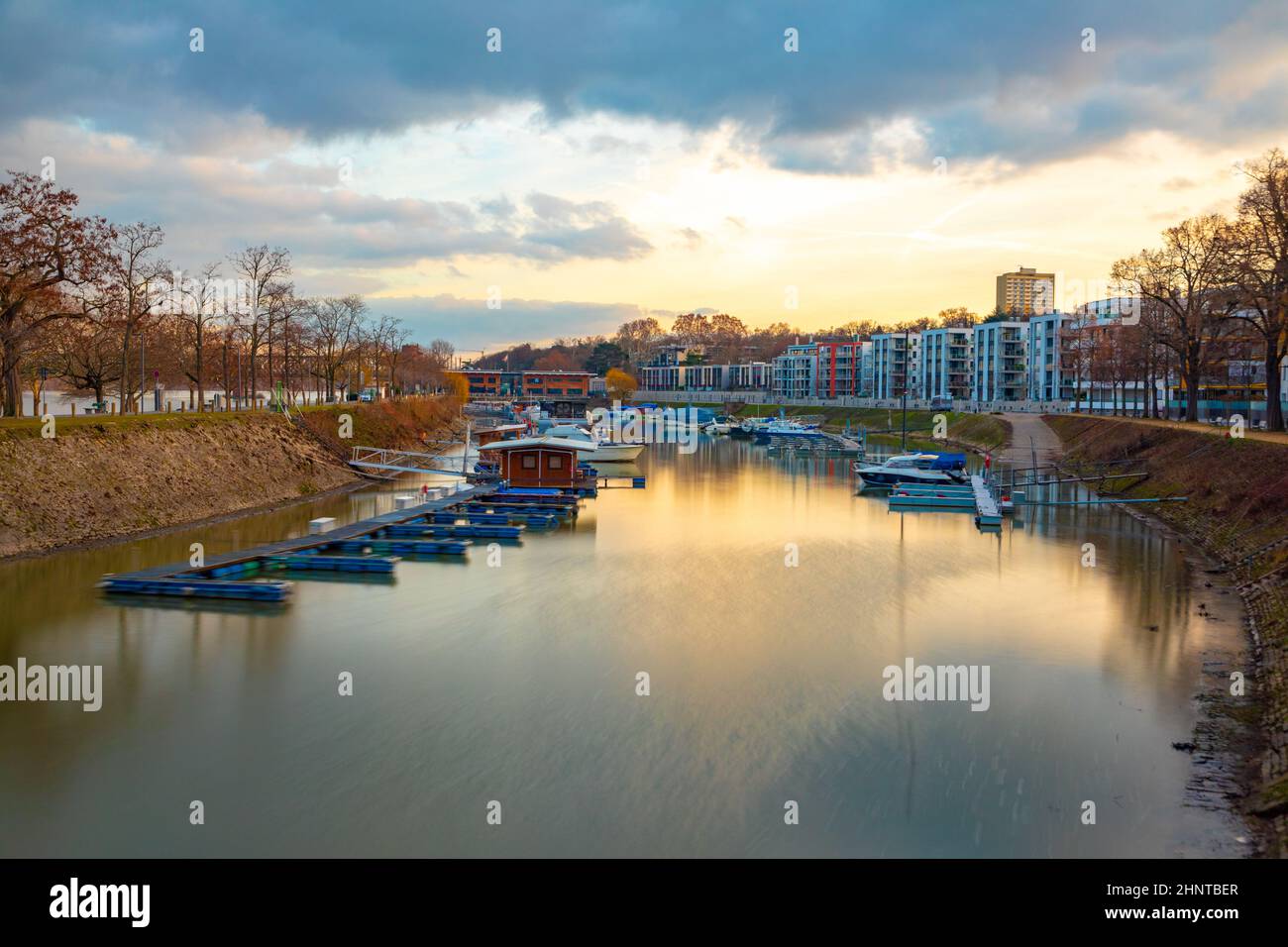 ships anchor in the yacht harbor in Mainz in sunset at river Rhine ...