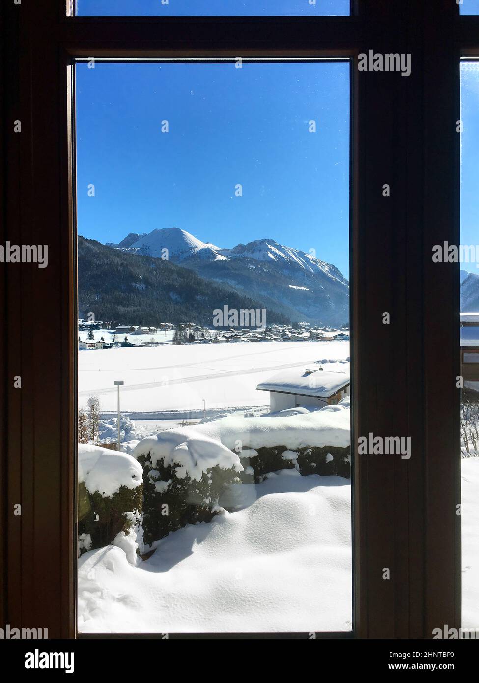 scenic winter snow landscape in Tyrol, Austria seen from a window in a ...
