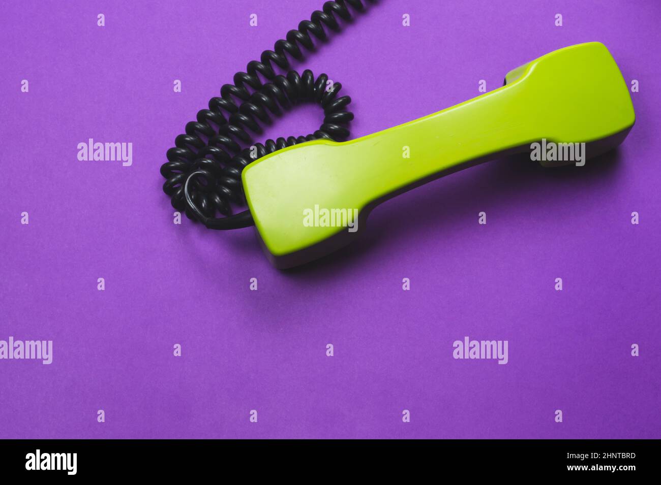 Vintage telephone handset. phone receiver isolated on purple background ...