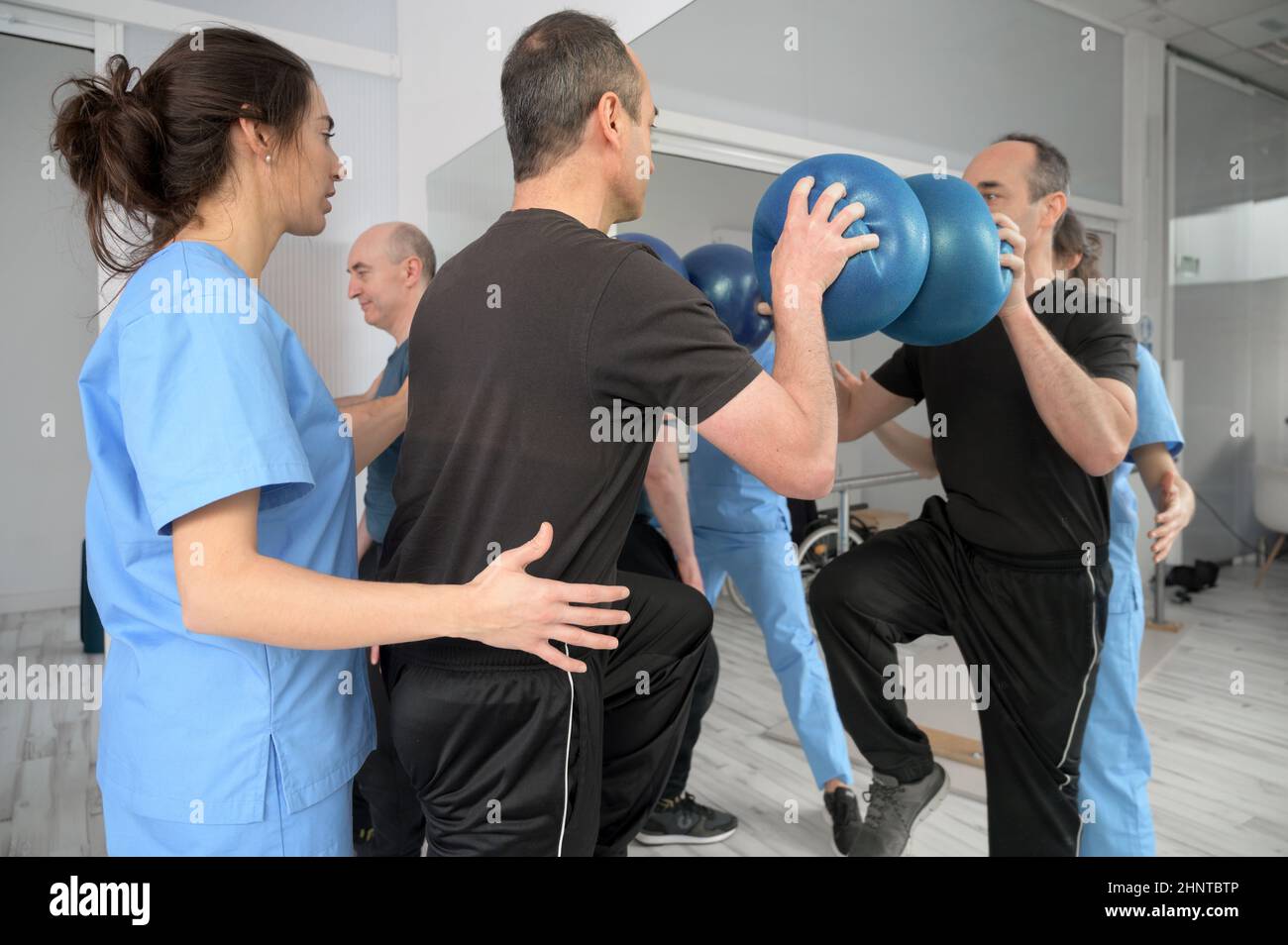 Group of People with disability exercising at rehabilitation clinic ...