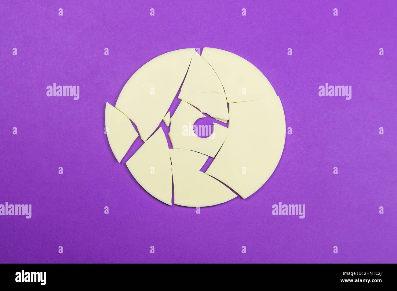 White broken disc on color background Stock Photo - Alamy