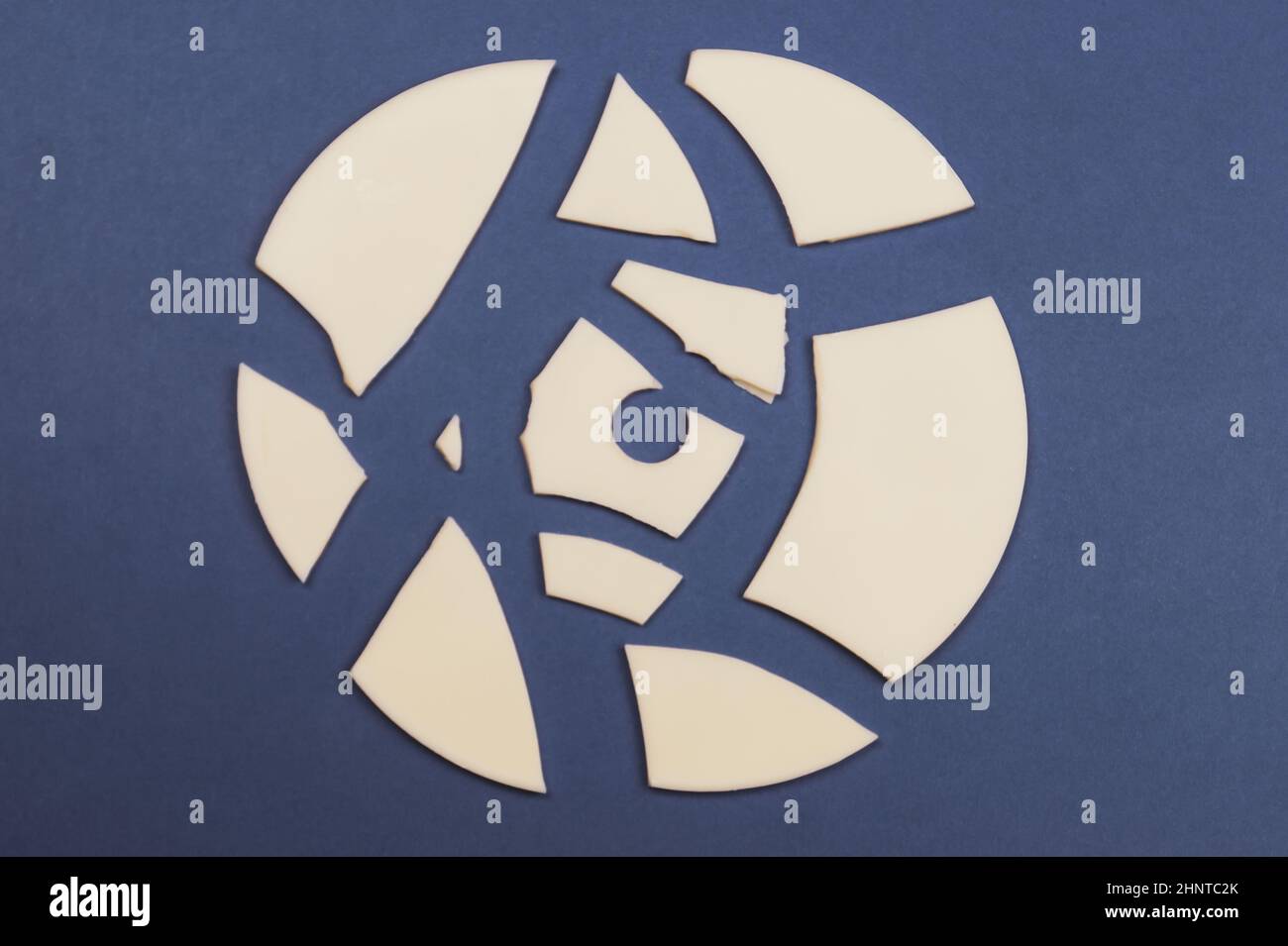 White broken disc on color background Stock Photo - Alamy