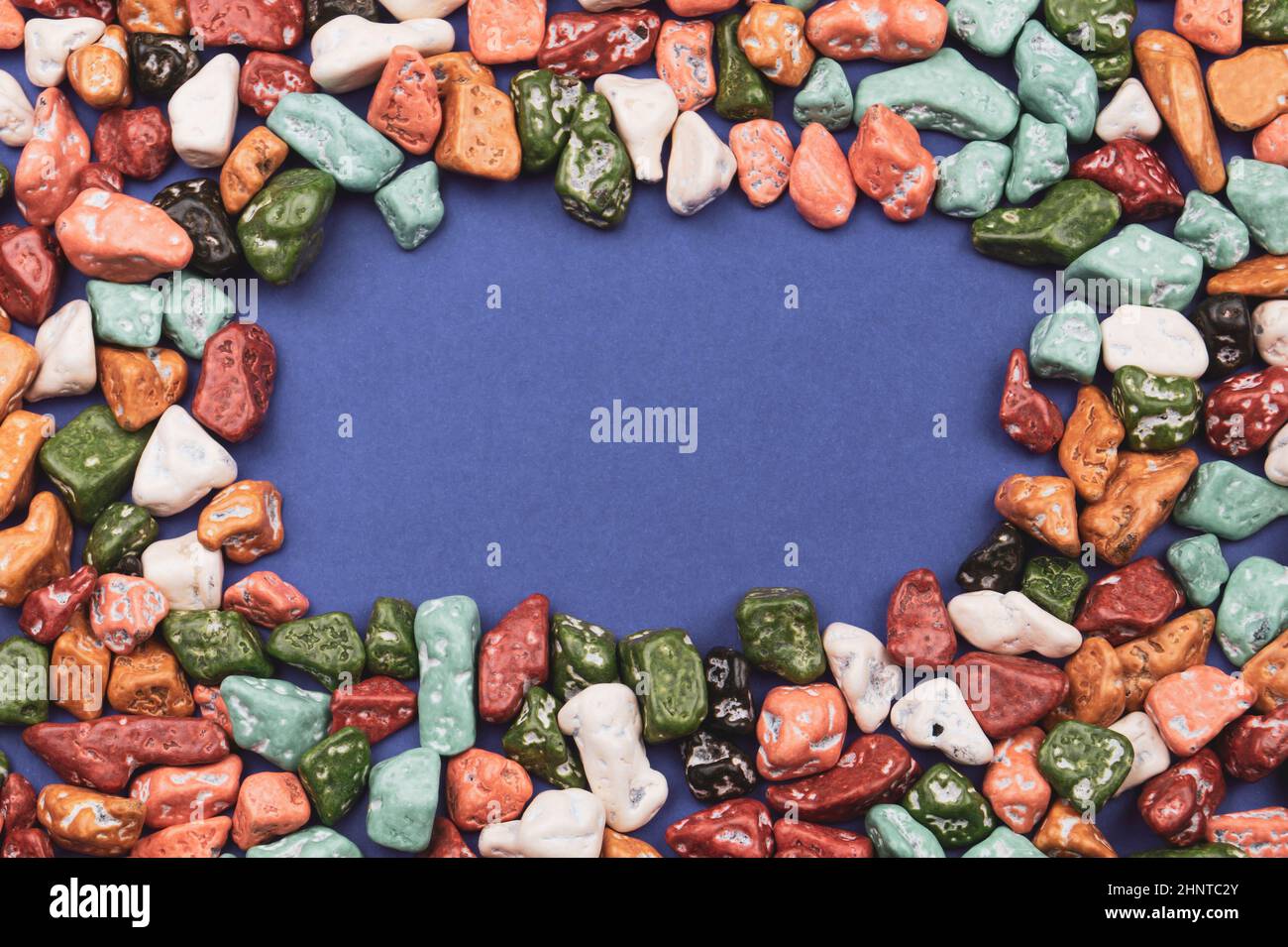 Candy pebbles. sweets in the form of colored stones. frame made from ...