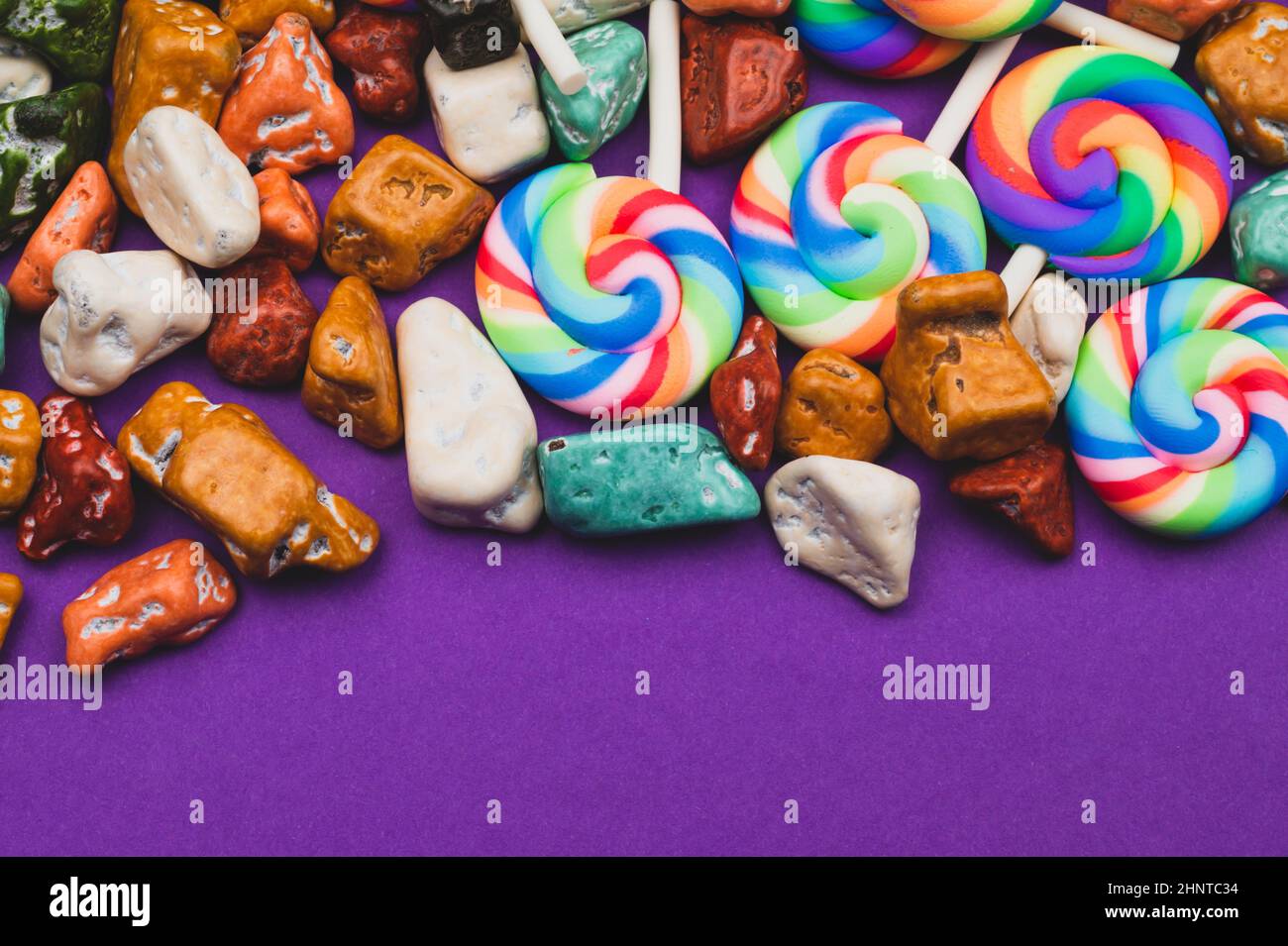Lollipops and candy pebbles. sweets in the form of colored stones ...