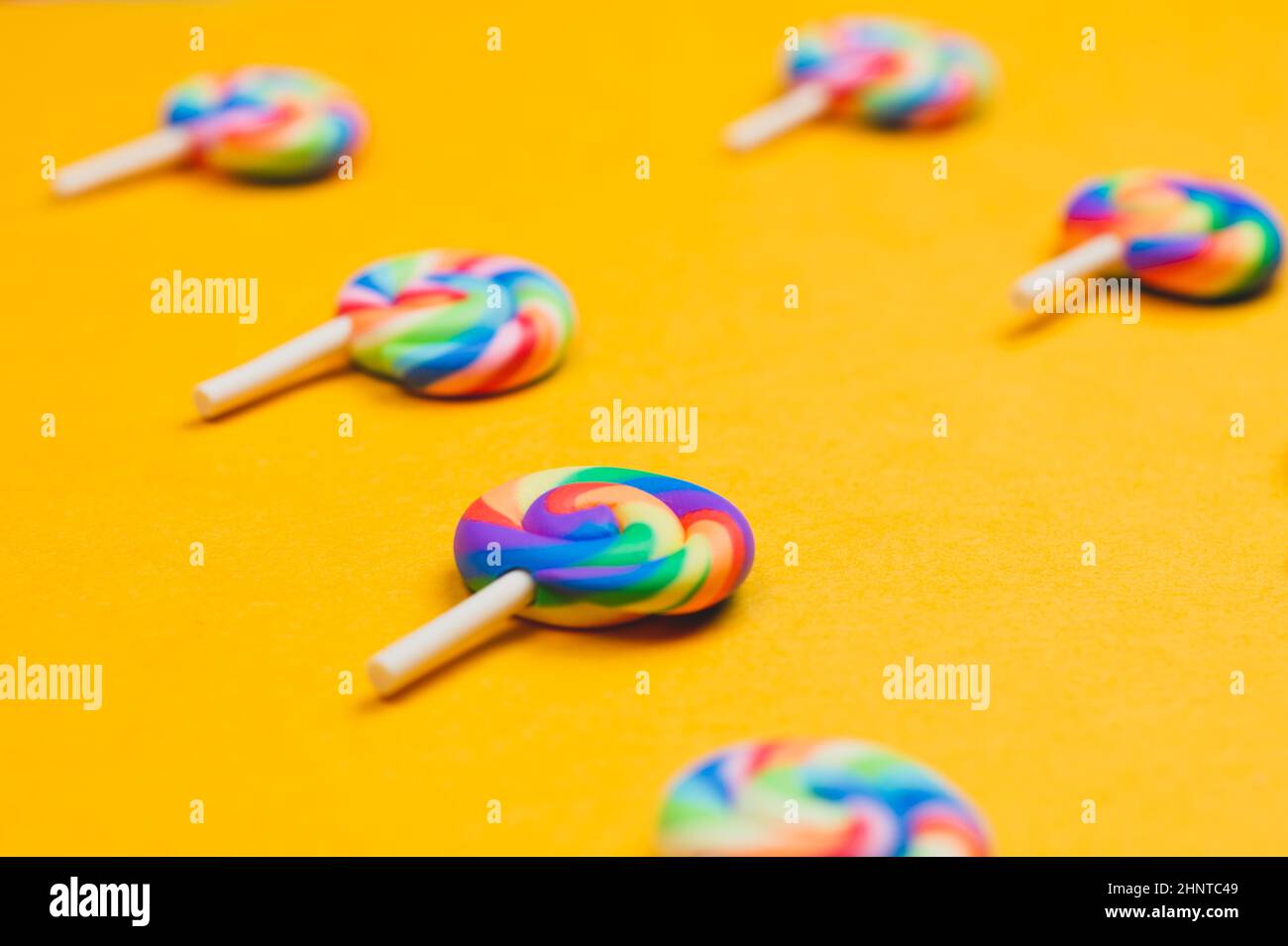 Lollipops are in a row. spiral candy pattern. lots of sweets on a ...