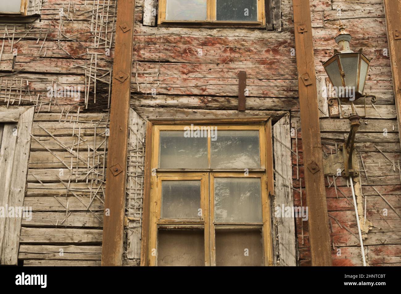 Windows of the old wooden house. wooden plank wall with windows and ...