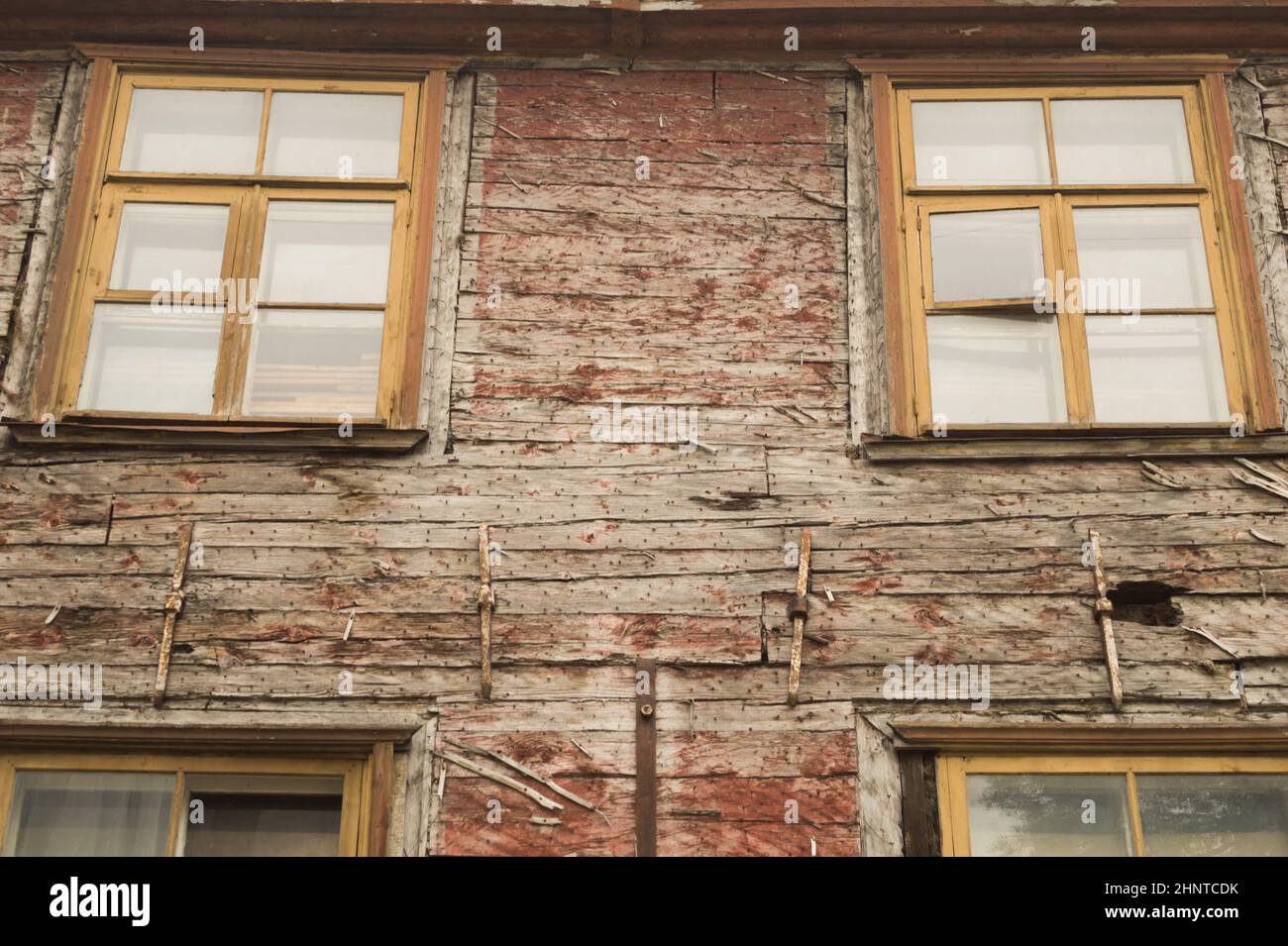 Windows of the old wooden house. wooden plank wall with windows ...