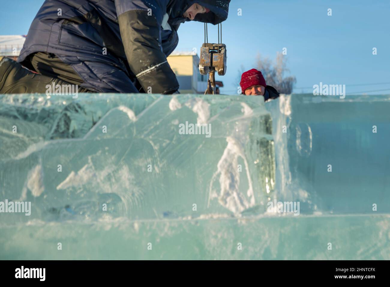 Two assembly workers stacking ice slabs on a construction site Stock ...