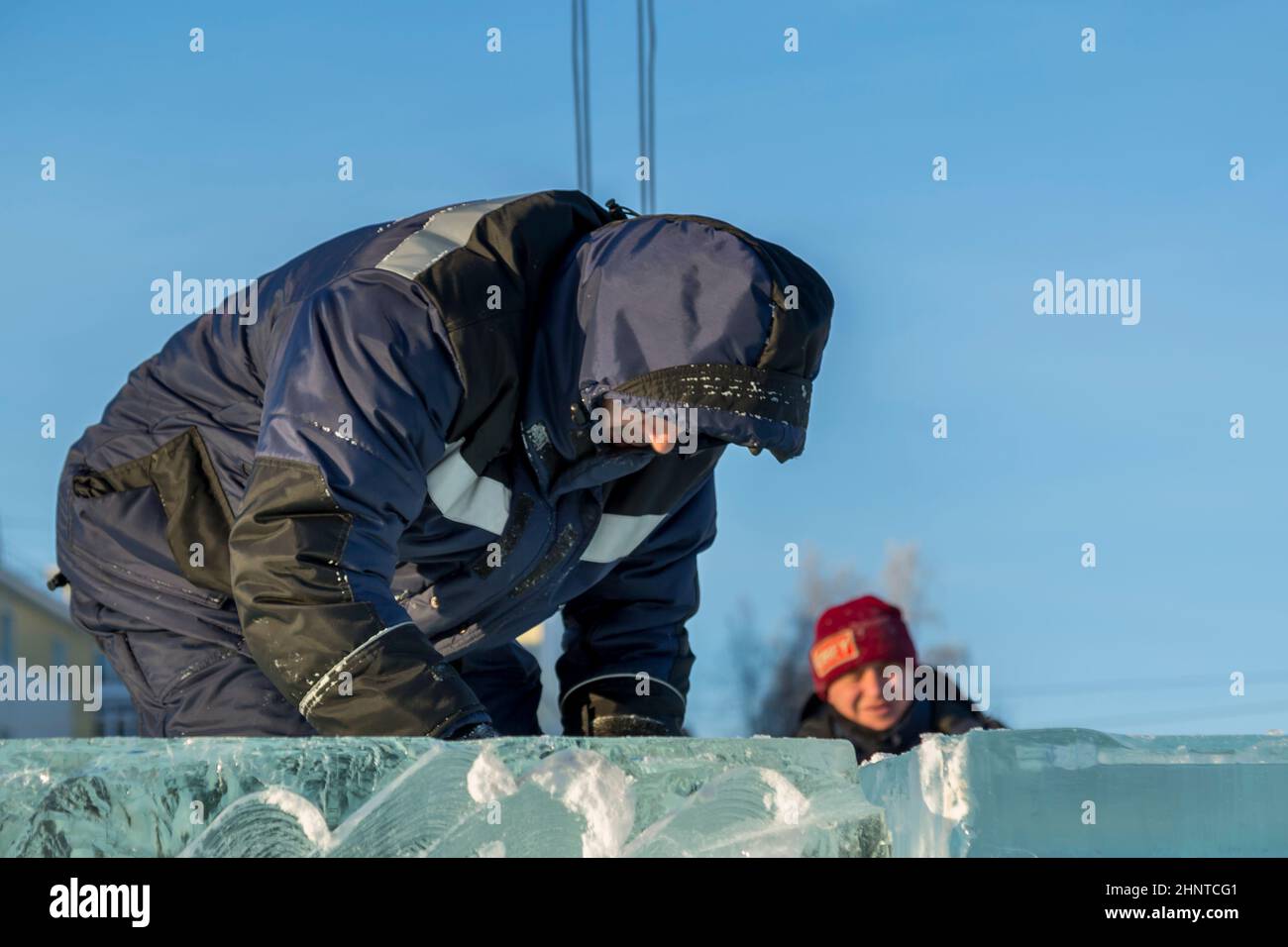Two assembly workers stacking ice slabs on a construction site Stock ...