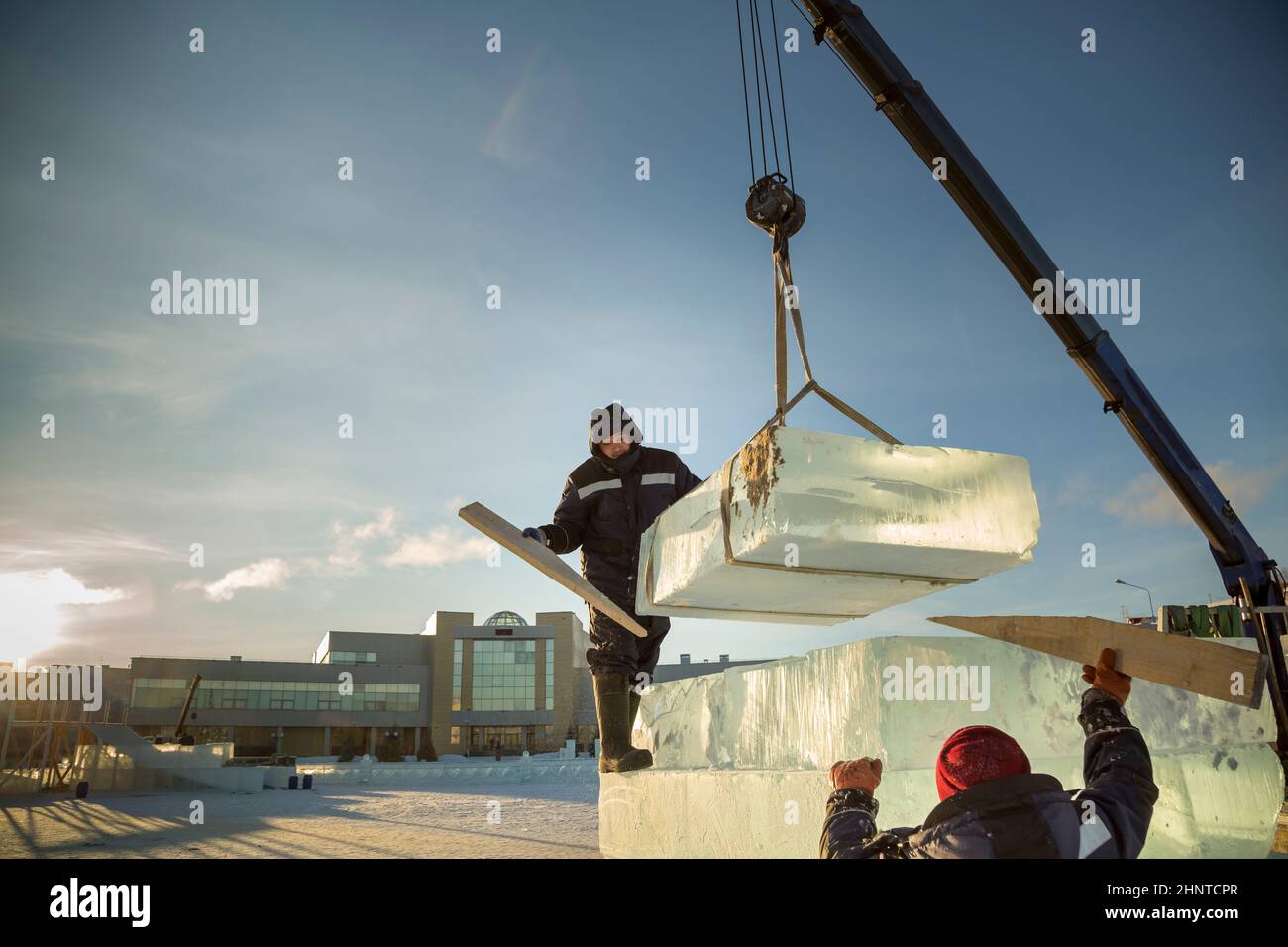 Two assembly workers stacking ice slabs on a construction site Stock ...