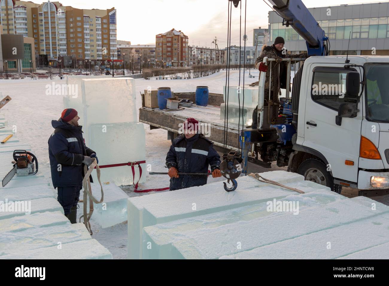Two assembly workers stacking ice slabs on a construction site Stock ...